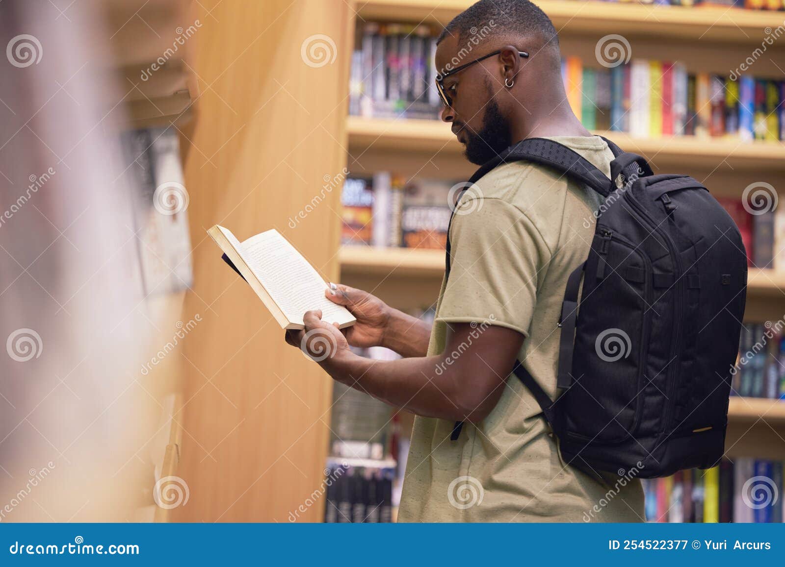 Education Student with Book in a Library at University, College or ...