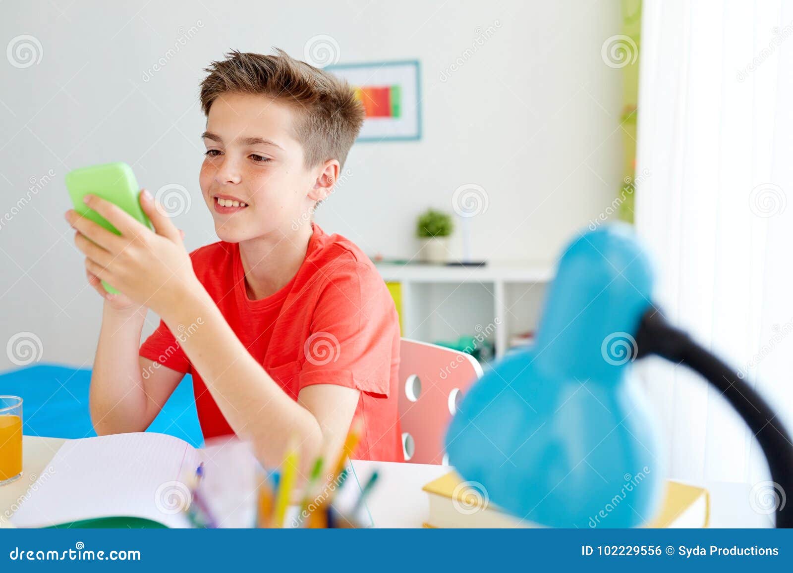Student Boy with Smartphone Distracting from Study Stock Photo - Image ...