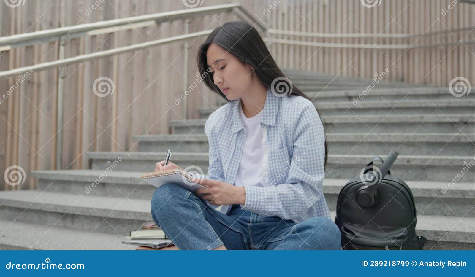 Education in University College Concept - Young Lady Making Notes in ...