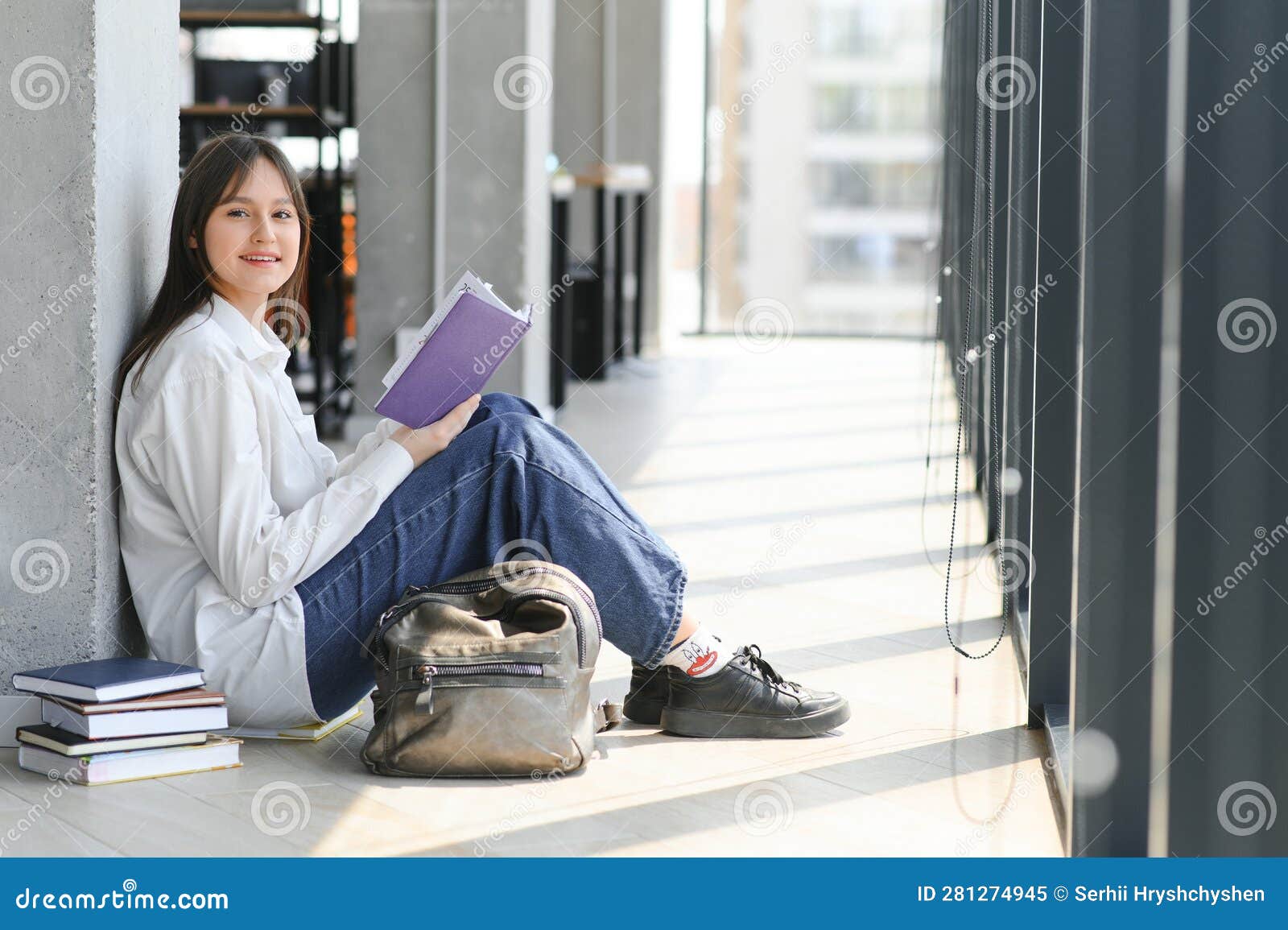 Educational Concept. a Modern Girl Student Sits on the Floor and ...