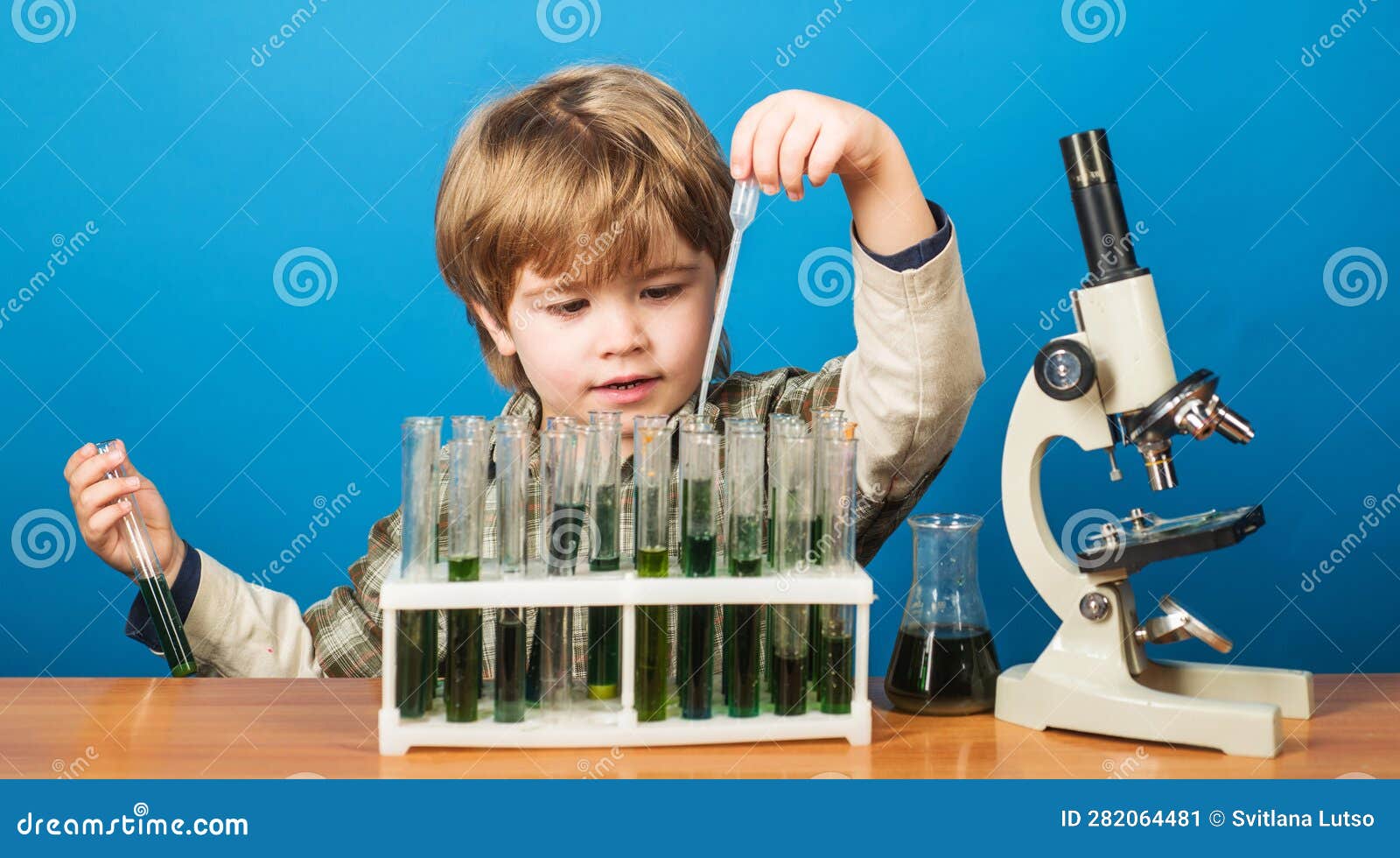 Educational Experiment. Boy with Test Tubes and Microscope in School ...