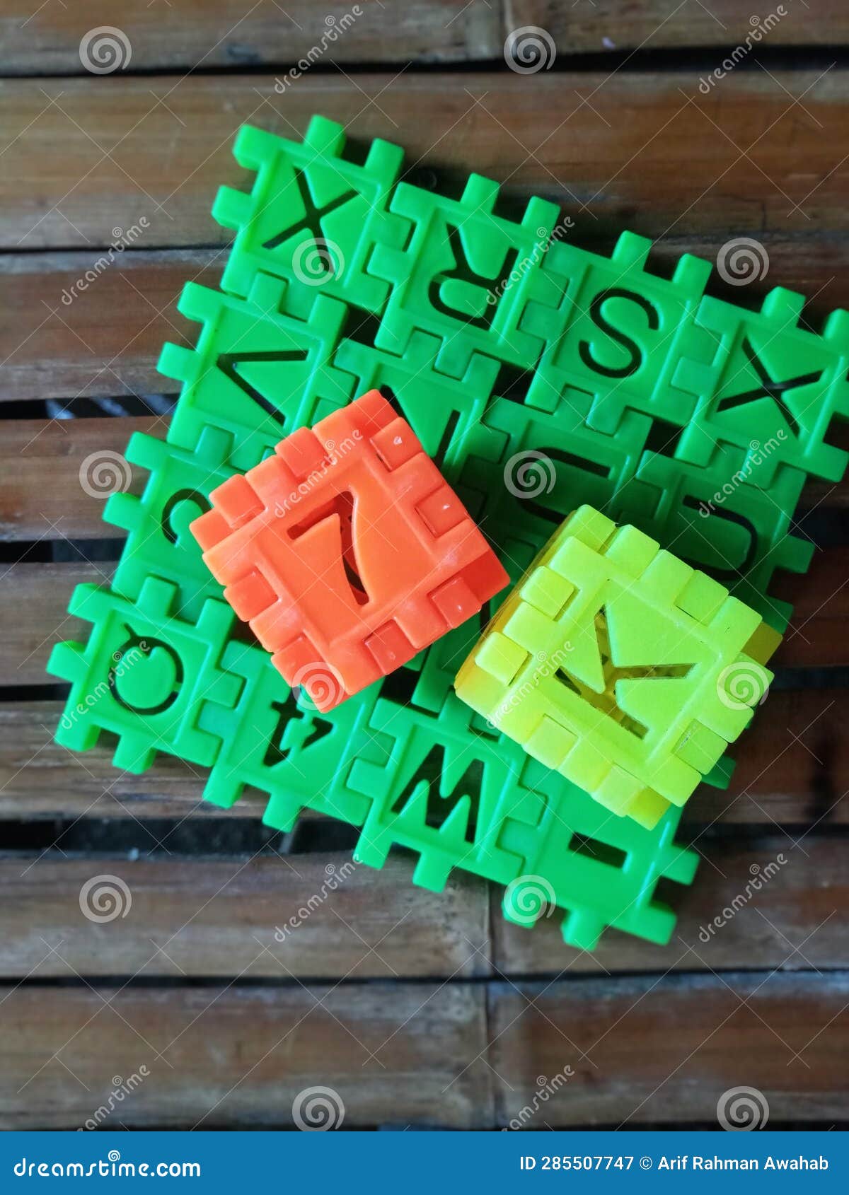 Educational Plastic Puzzle Toy Called Building Blocks on Bamboo Surface ...