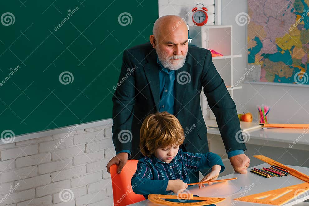 Educational Process. Elementary School Teacher Giving Female Pupil ...