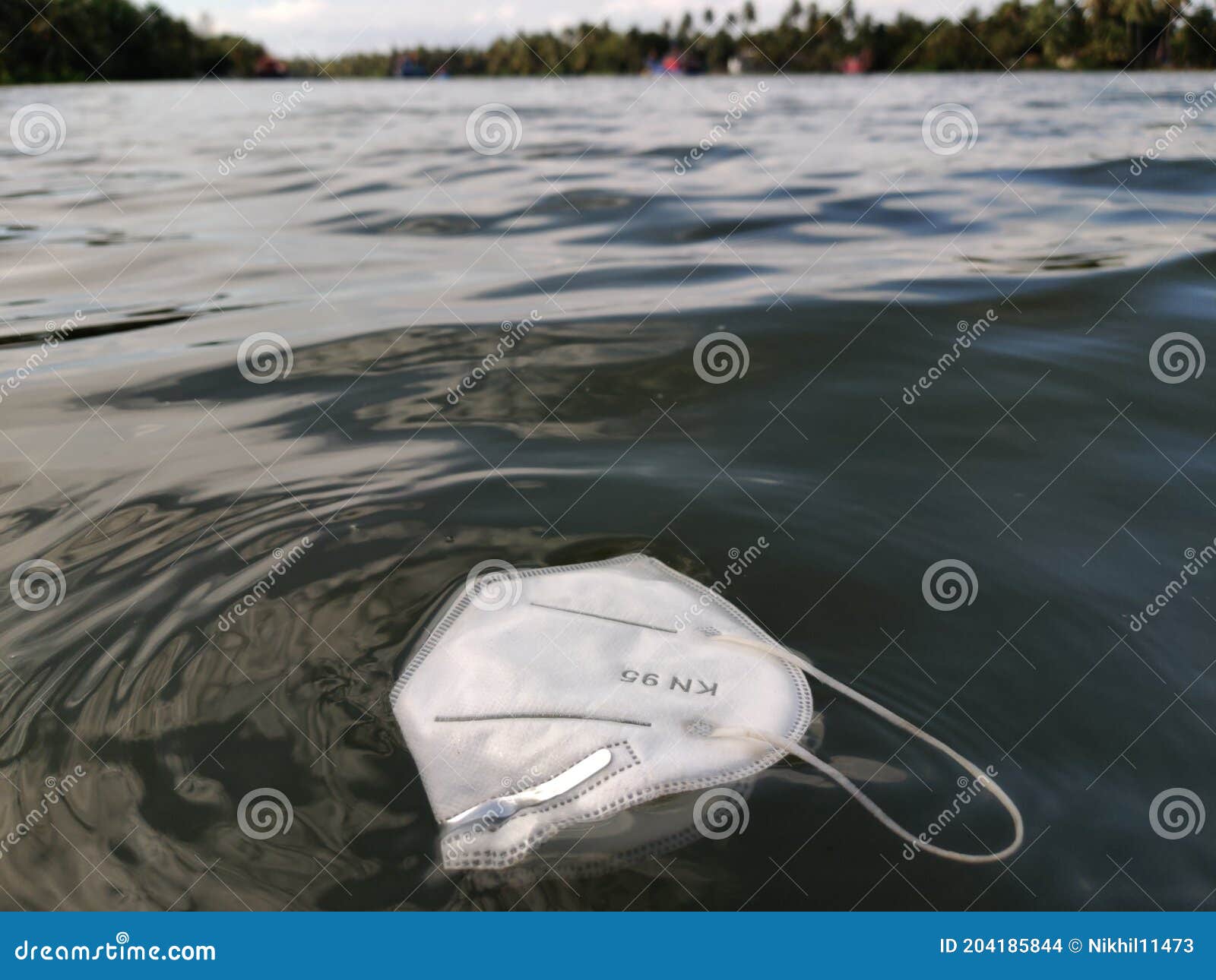After Effect of COVID N 95 Face Mask Floating on the Surface of Water ...