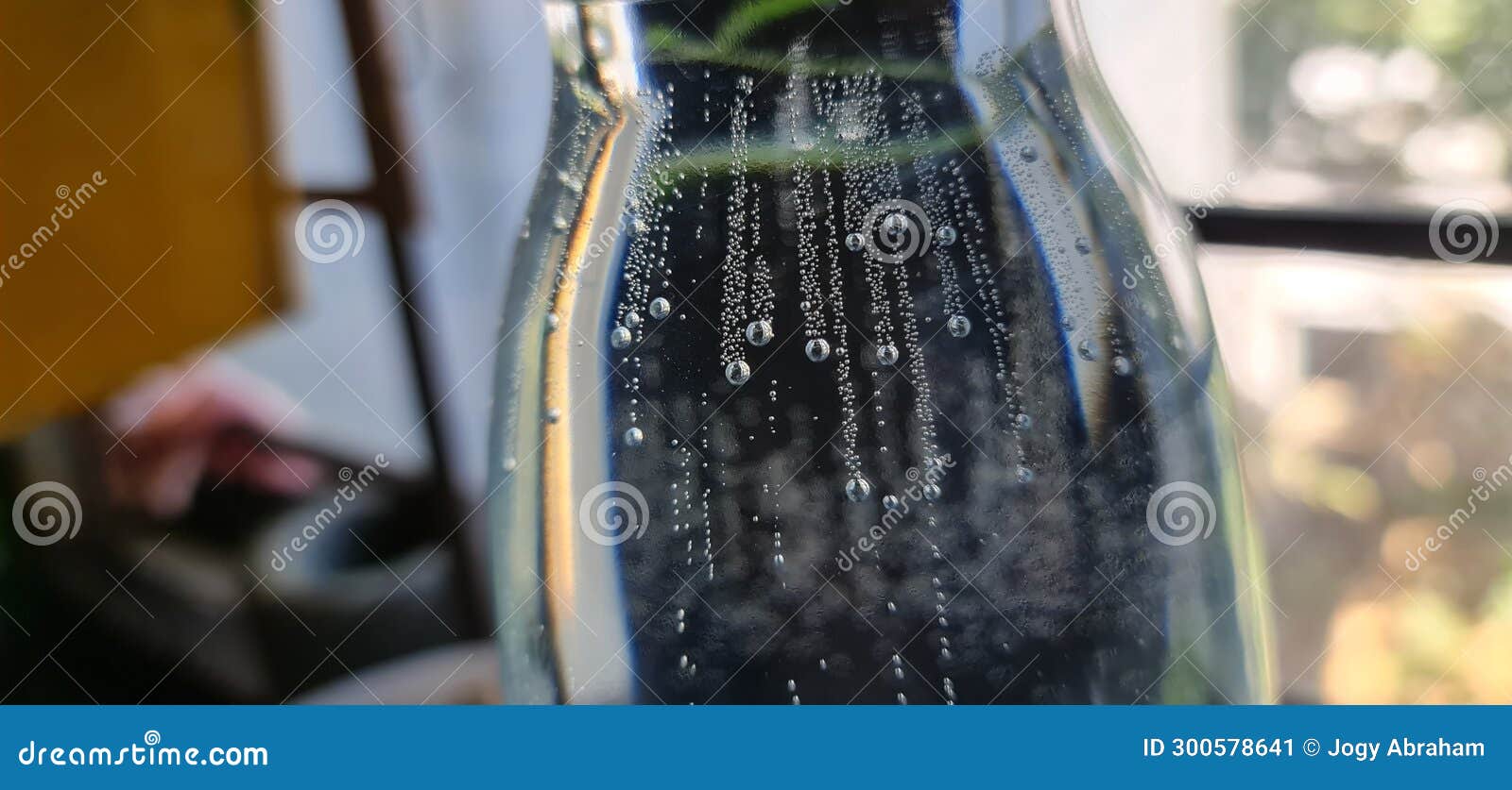 Effervescent Bubbles Dance in a Glass Bottle Filled with Crisp Drinking ...