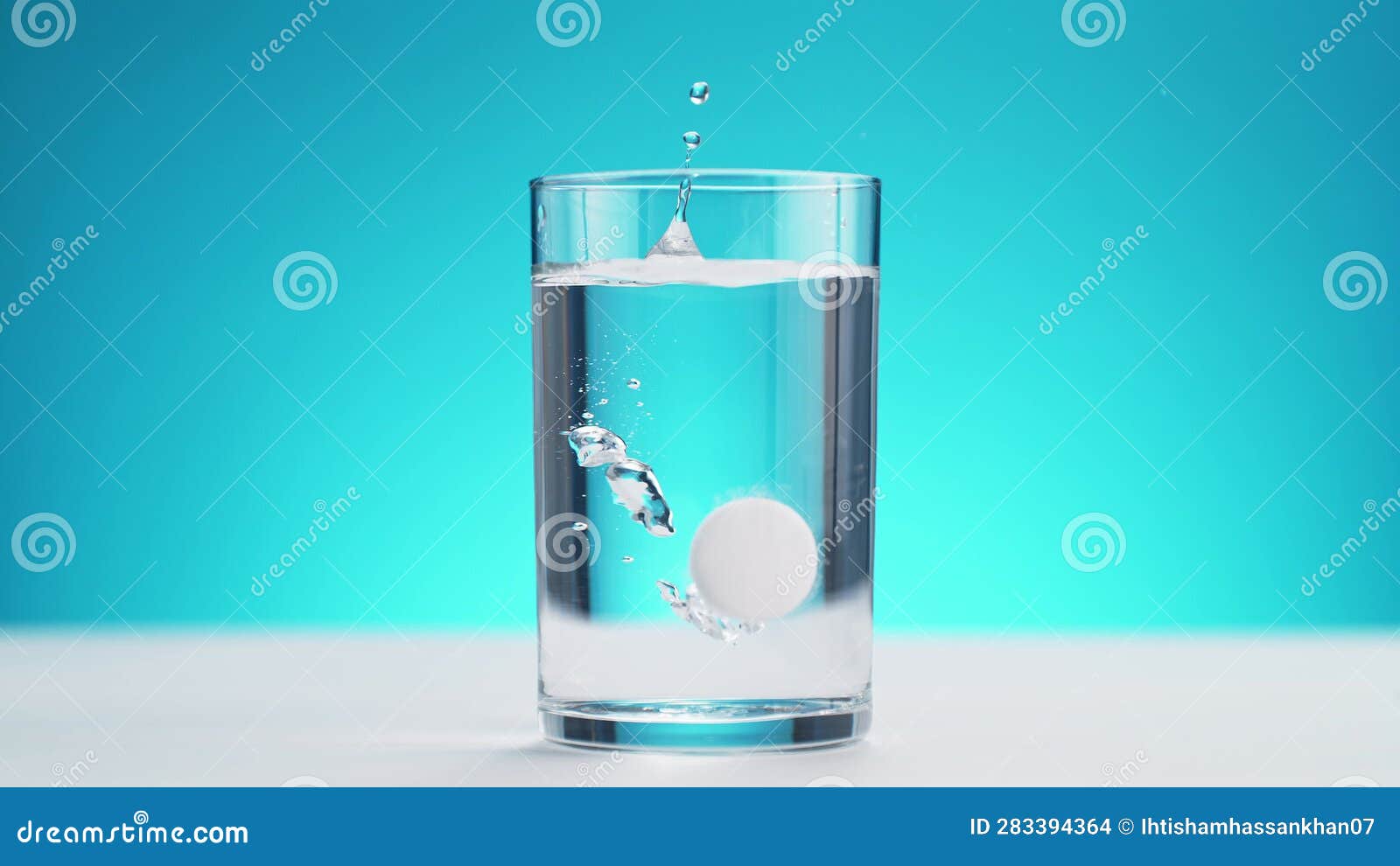 Effervescent Tablet Falling into Glass of Pure Water Standing on Table ...