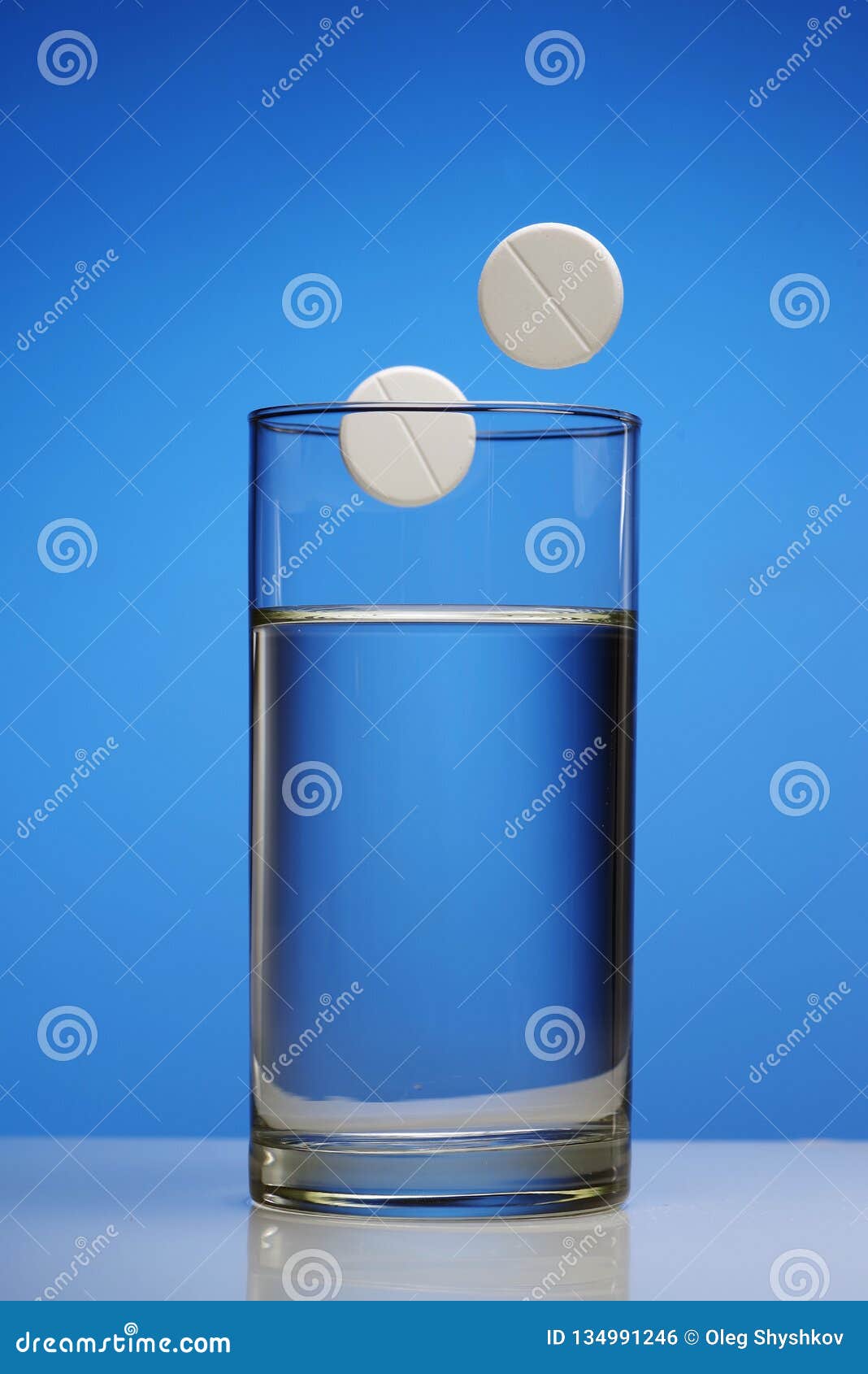 A Glass with Effervescent Tablets on a Blue Background. Stock Photo ...