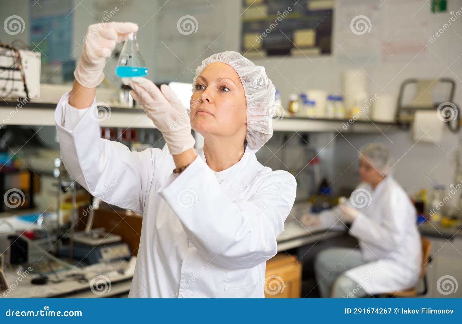 Efficient Female Lab Technician Working with Reagents in Test Tubes ...