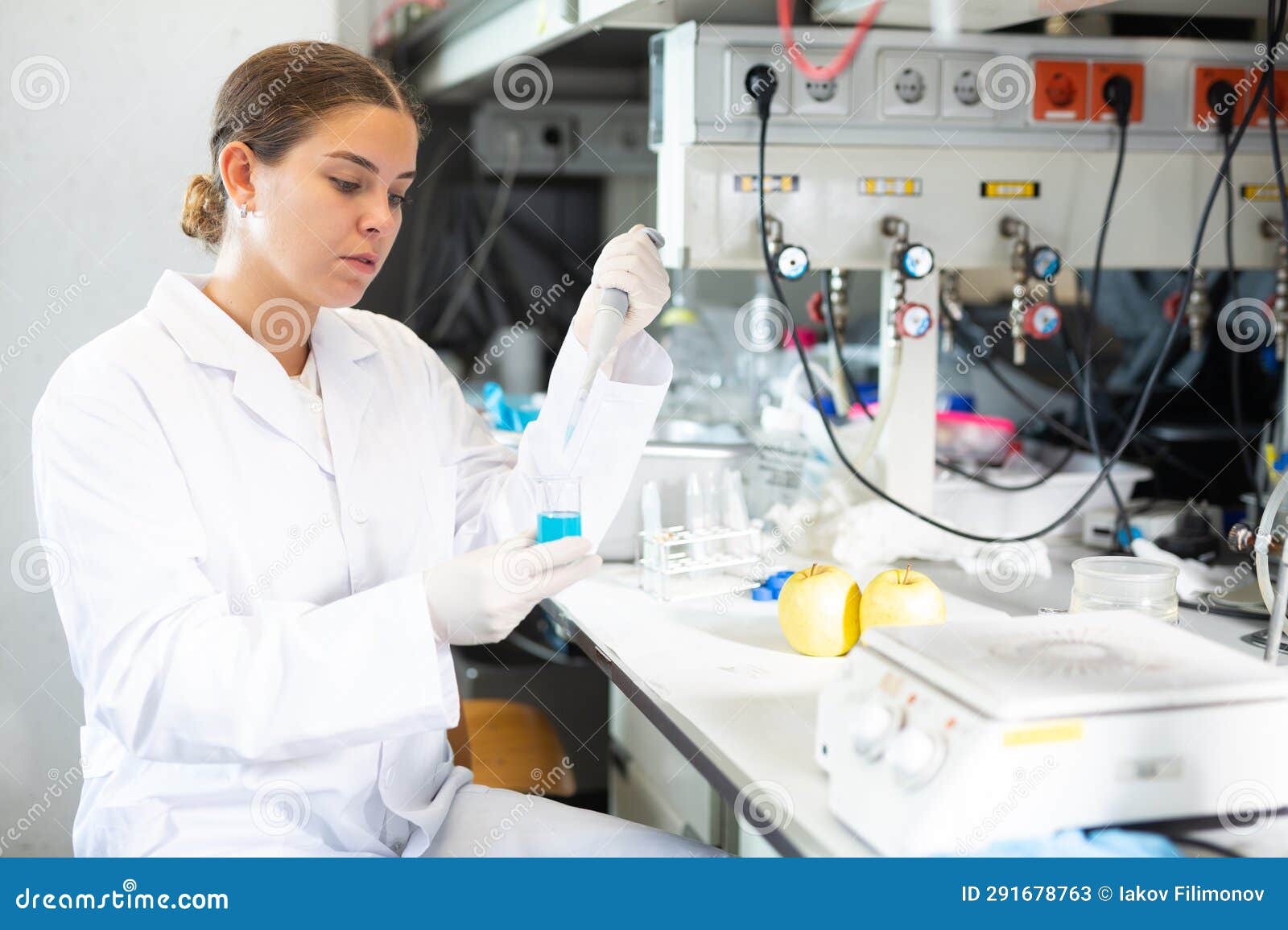 Efficient Female Lab Technician Working with Reagents in Test Tubes ...