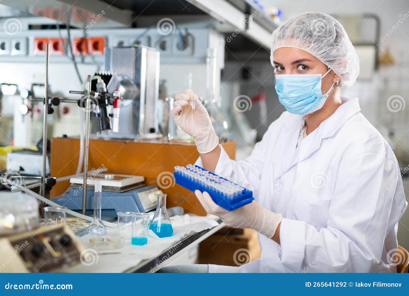 Efficient Female Lab Technician Working with Reagents in Test Tubes ...