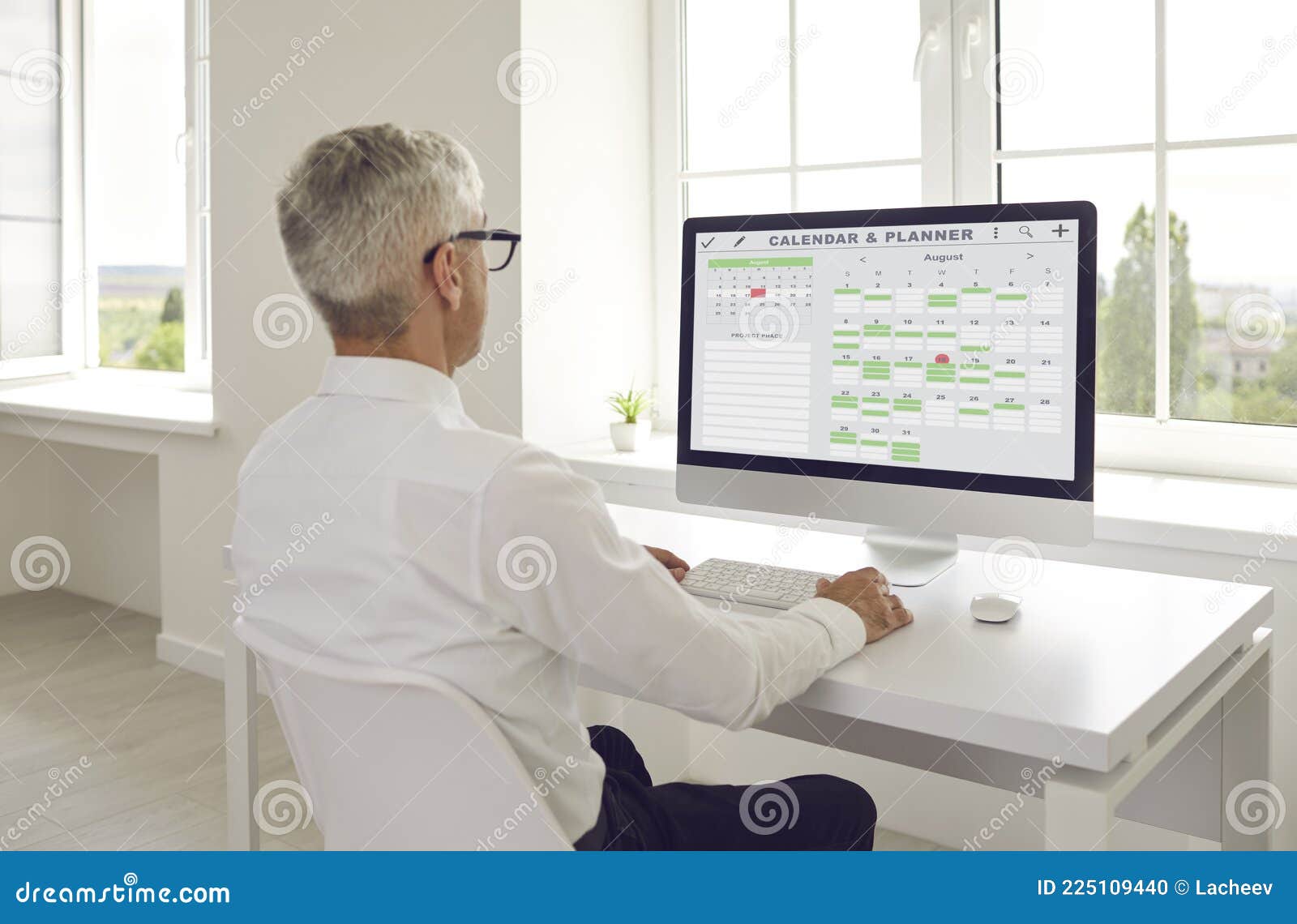 Senior Manager Organizing Schedule Using Calendar and Planner on Office ...
