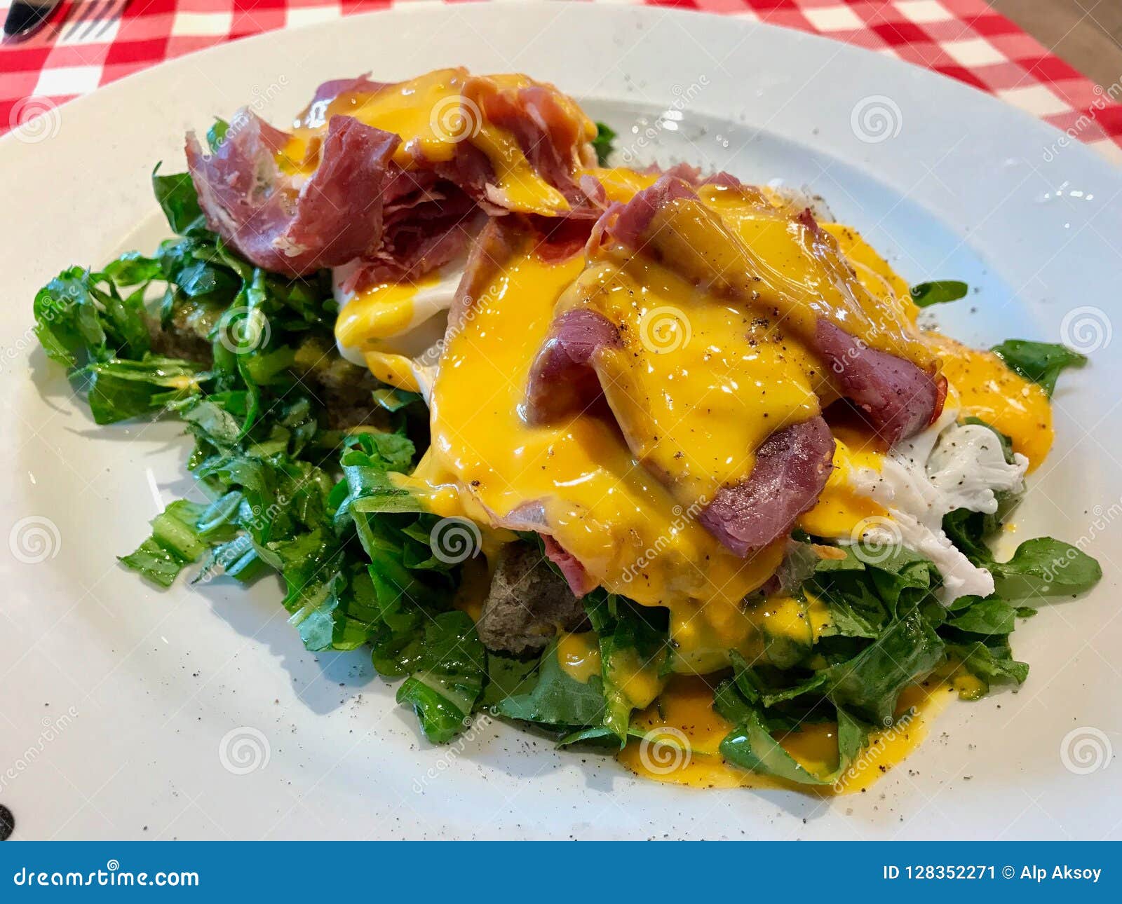 Egg Benedict with Bacon and Salad Served at Restaurant for Breakfast ...