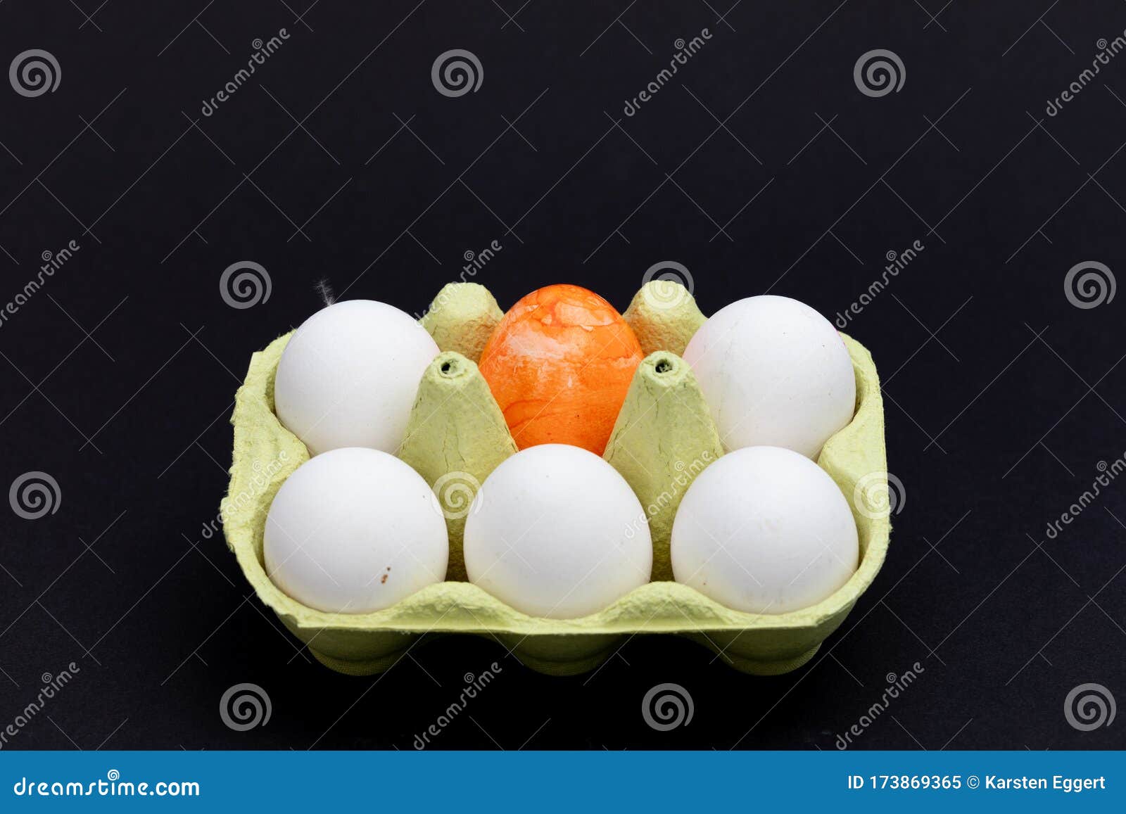 Egg Box with Five White and One Coloured Egg Stands on a Dark Base ...