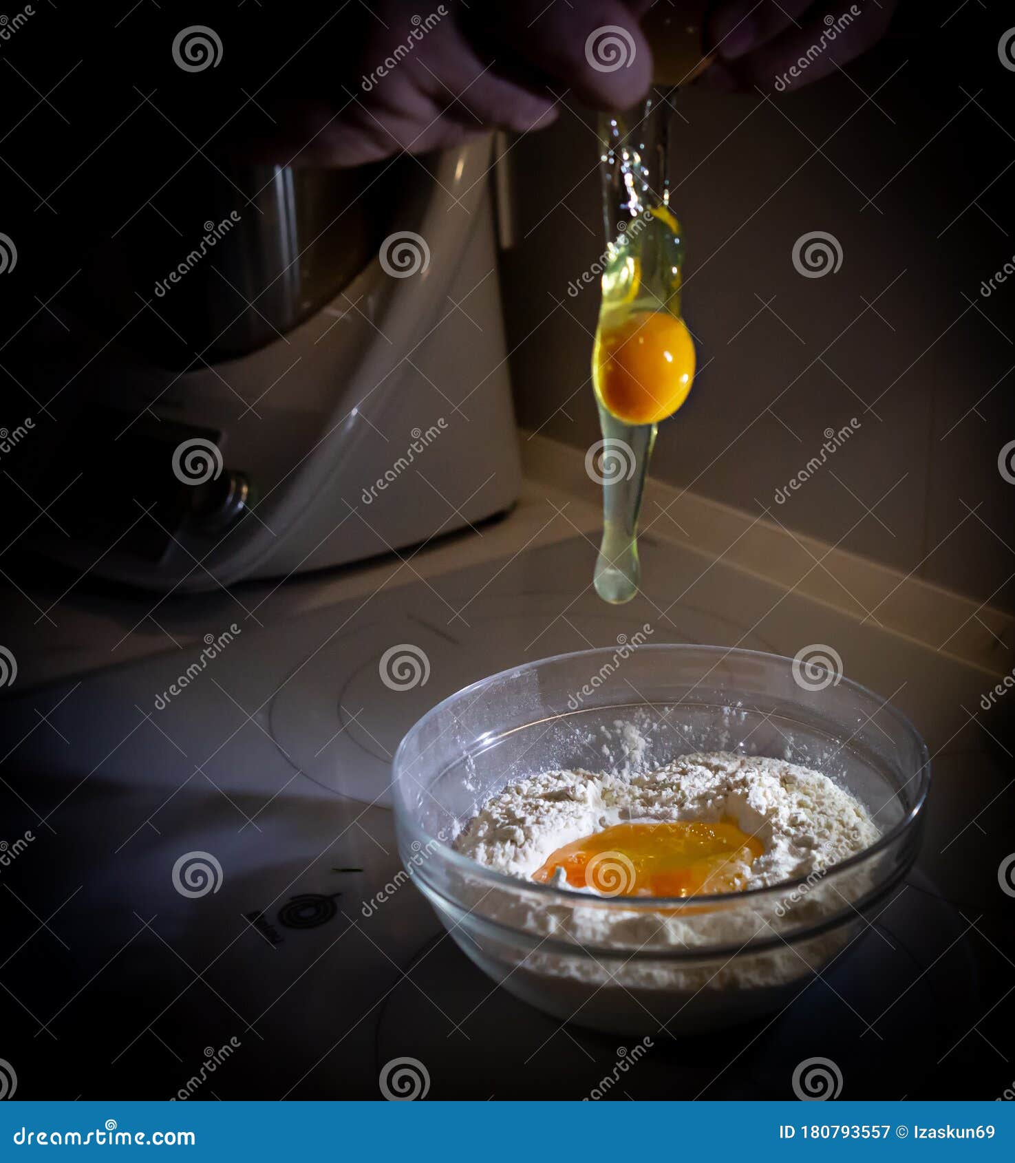 Egg falling into the flour editorial photography. Image of bakery ...