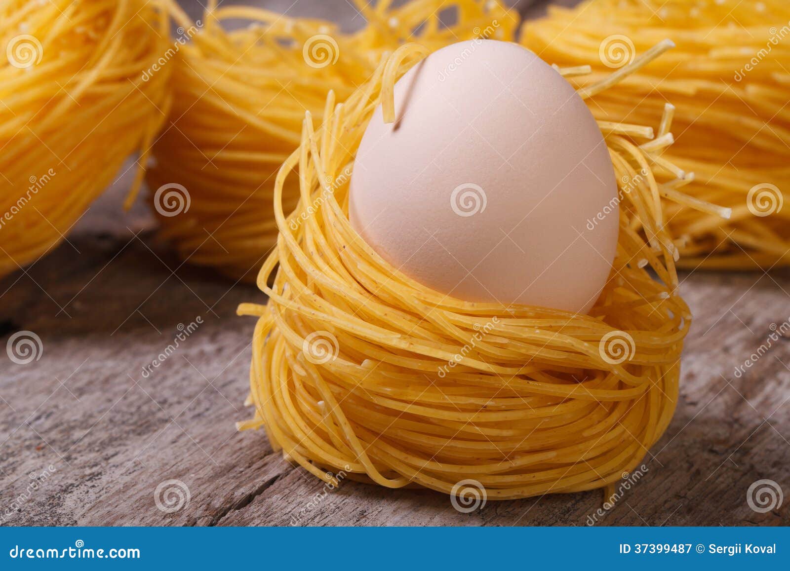 Egg Inside the Nest of Dry Macaroni Close Up Stock Image - Image of ...