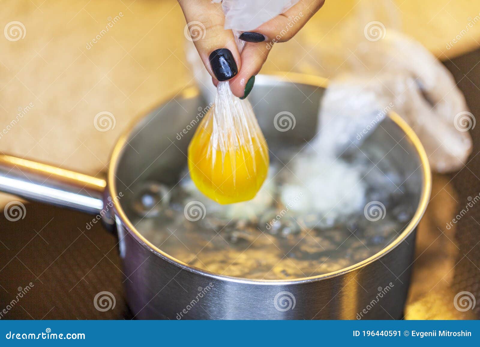 Egg poaching in water stock image. Image of benedict - 196440591