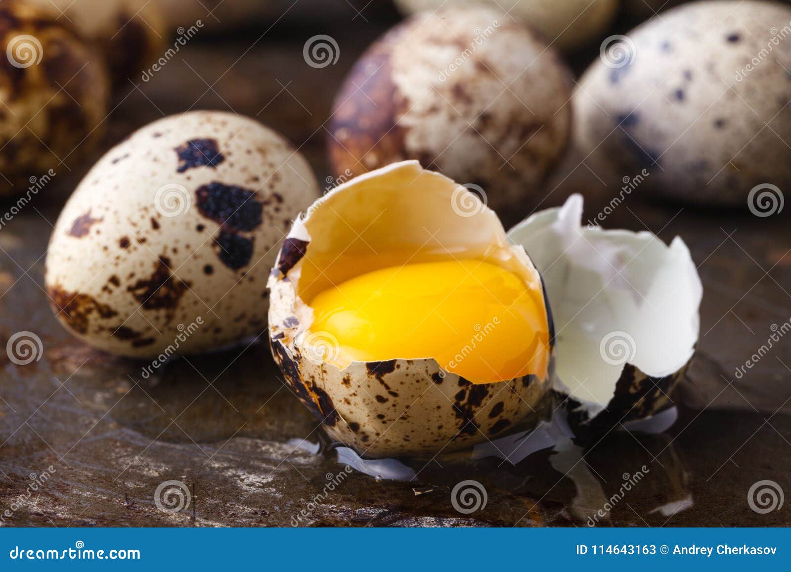 Egg Yolk in Brocken Quail Eggs on Rustic Table Stock Image - Image of ...