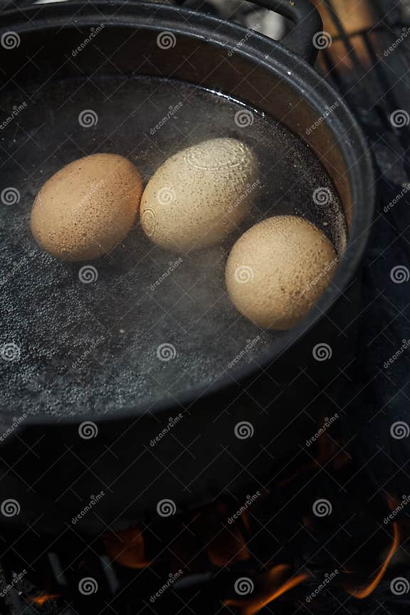 Eggs in a Cast Cauldron Full Boiling Water Stock Image - Image of ...