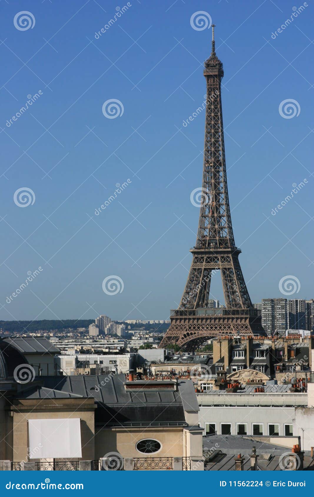 Eiffel tower above roofs stock photo. Image of building - 11562224
