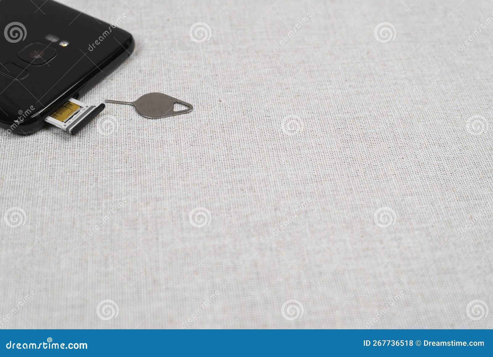 Eject Tool for Sim Card Tray of Smartphone and on Fabric Background ...