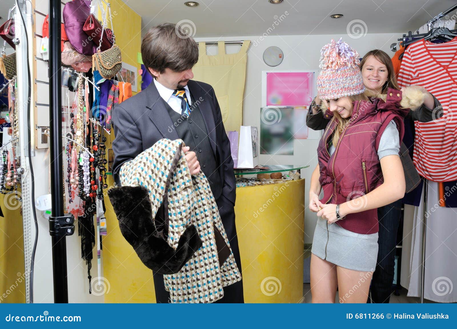 El Vendedor Ayuda a La Muchacha a Elegir La Ropa Foto de archivo ...