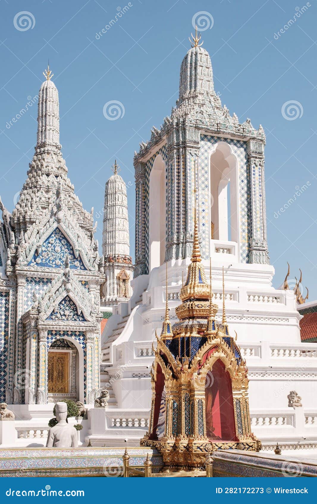 An Elaborate Structure at the End of a Fountain Next To a Tall Building ...