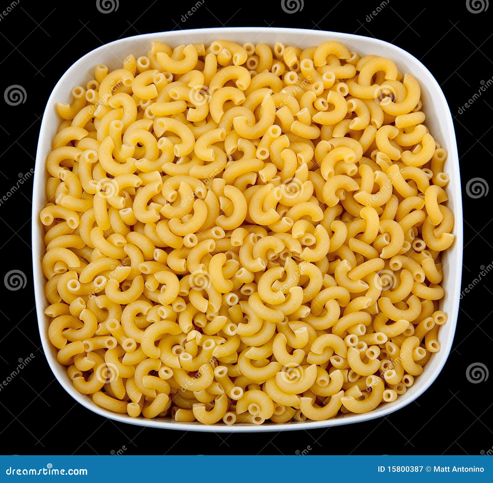 Elbow macaroni over black stock image. Image of dish - 15800387