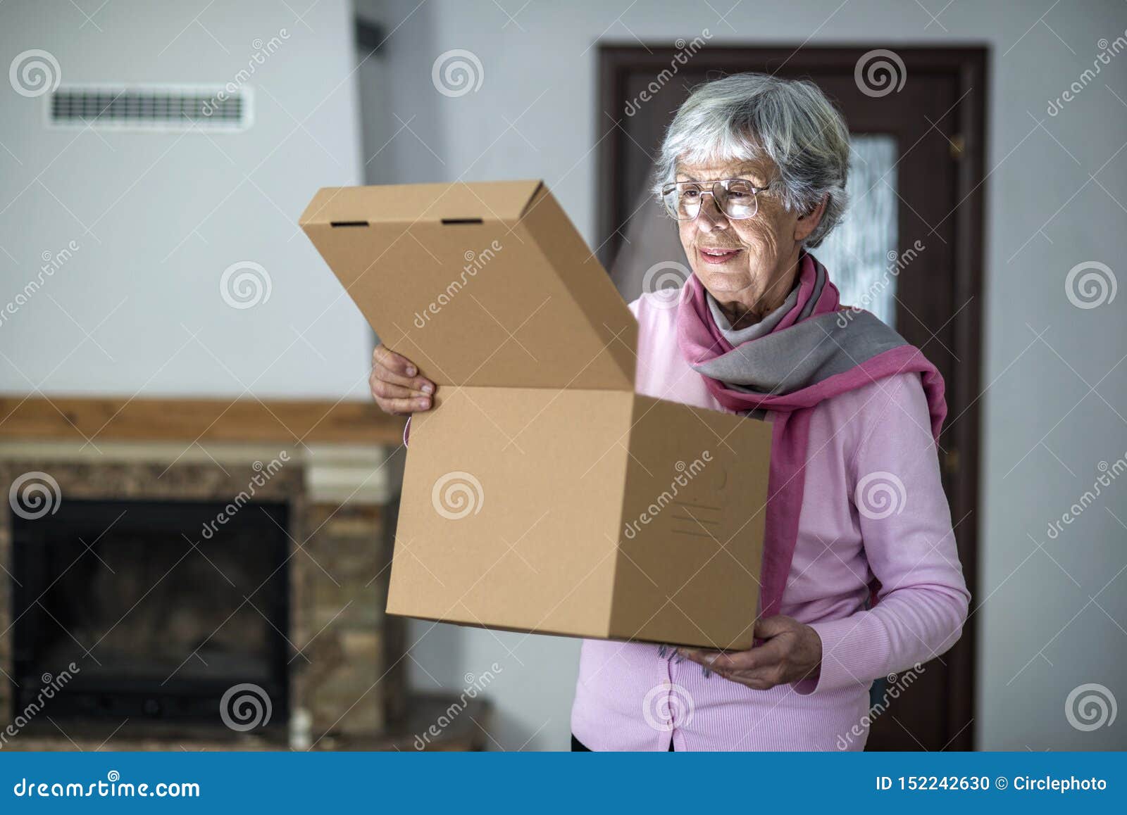 Elder Lady Opening a Delivery Box Stock Photo - Image of indoors ...