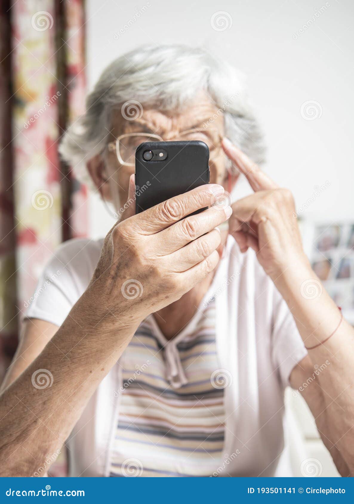 An Elder Lady Using a Smartphone Stock Image - Image of face, desk ...