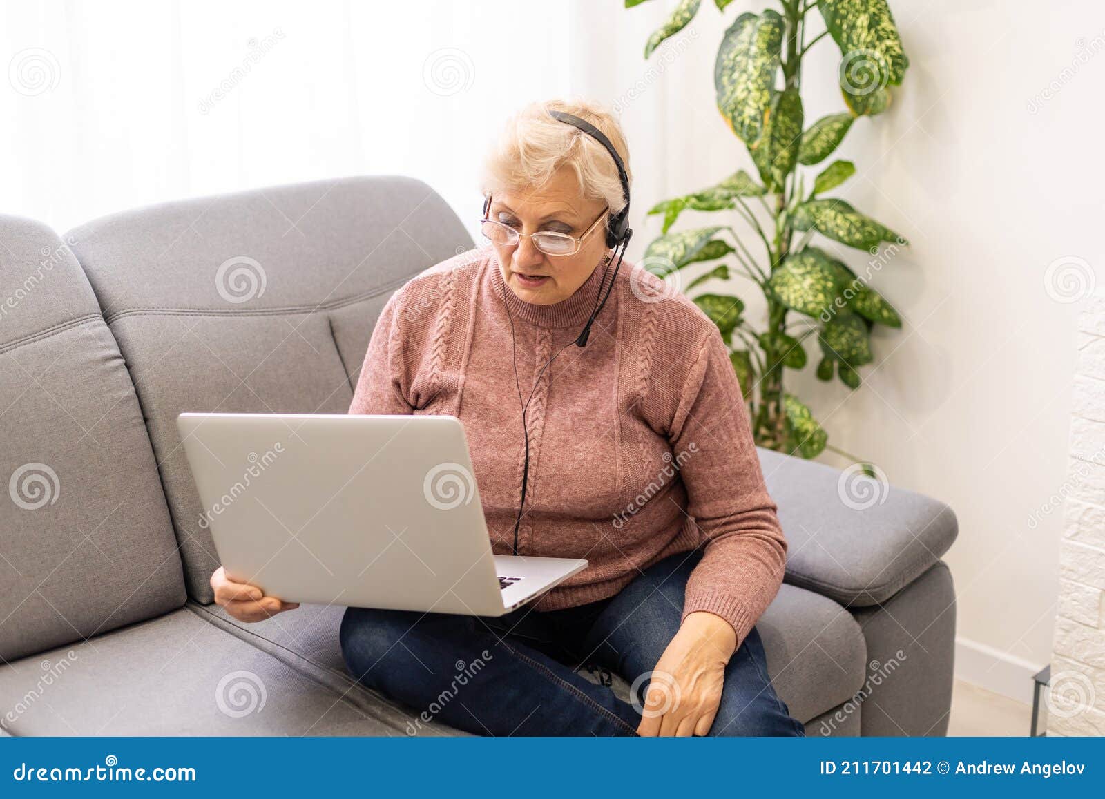 Elder Woman Using a Laptop Computer at Home Stock Photo - Image of ...