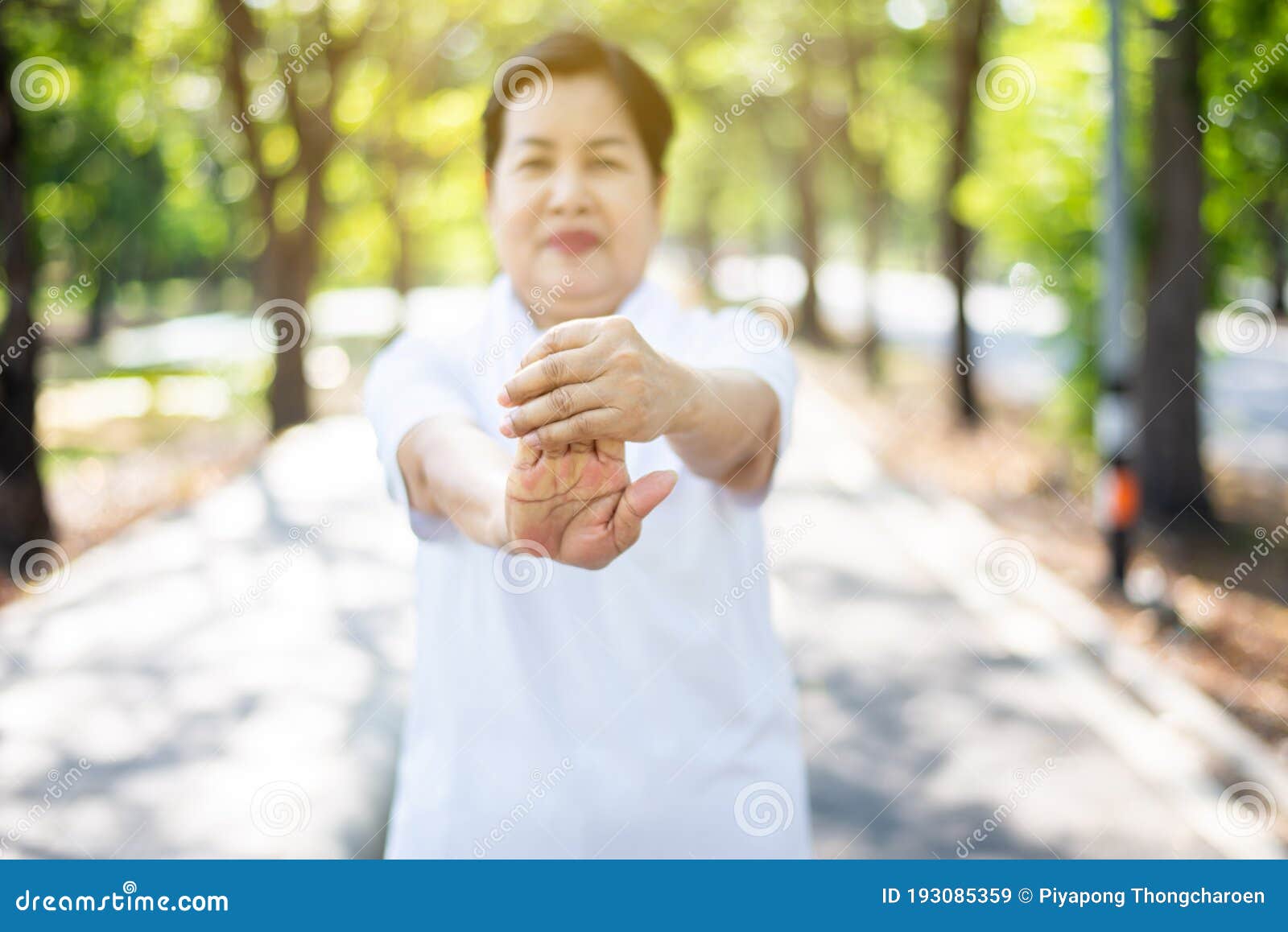 Elderly Asian Woman Stretching Before Workout In The Park Healthy