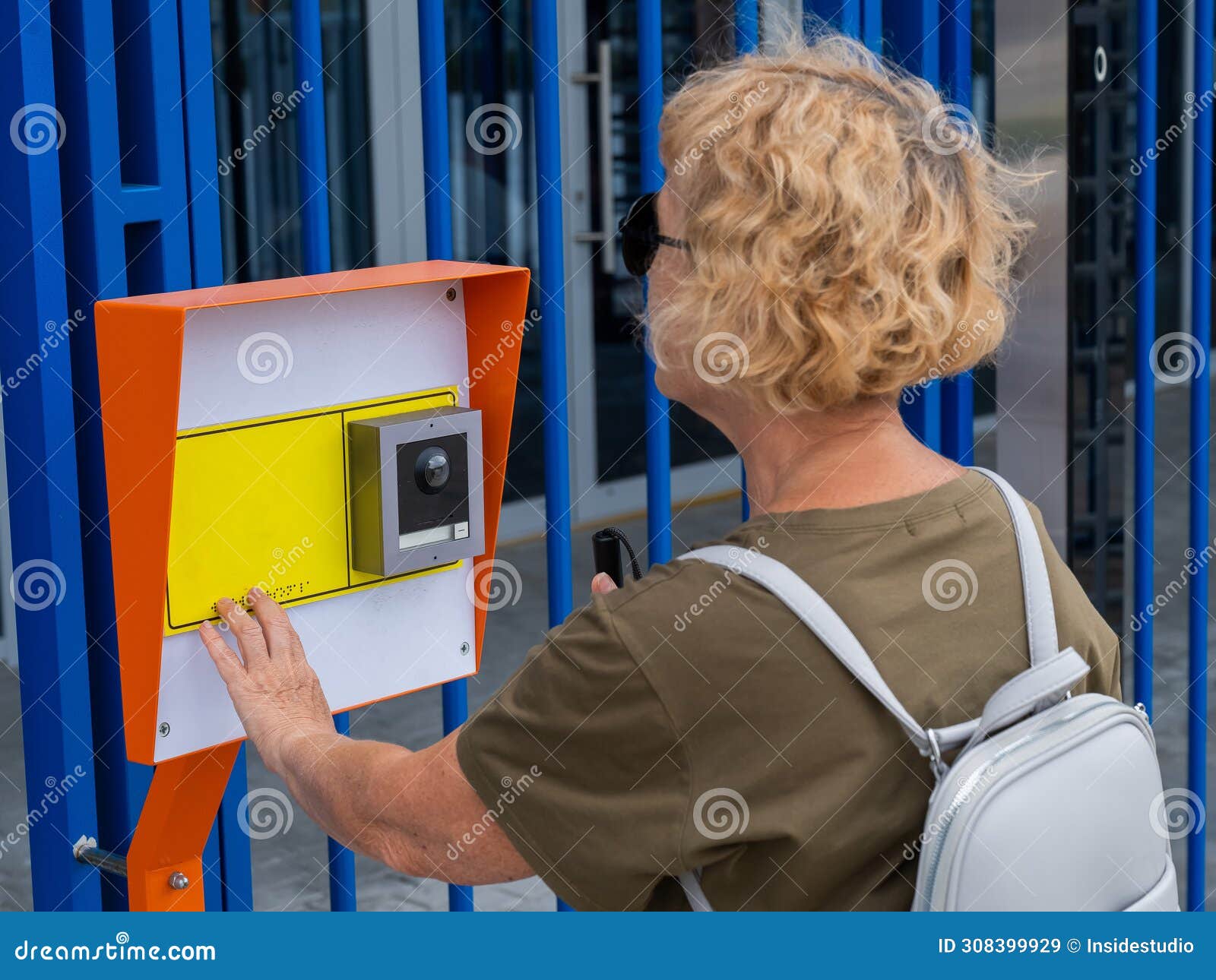 An Elderly Blind Woman Reading a Text in Braille. Button for Calling ...