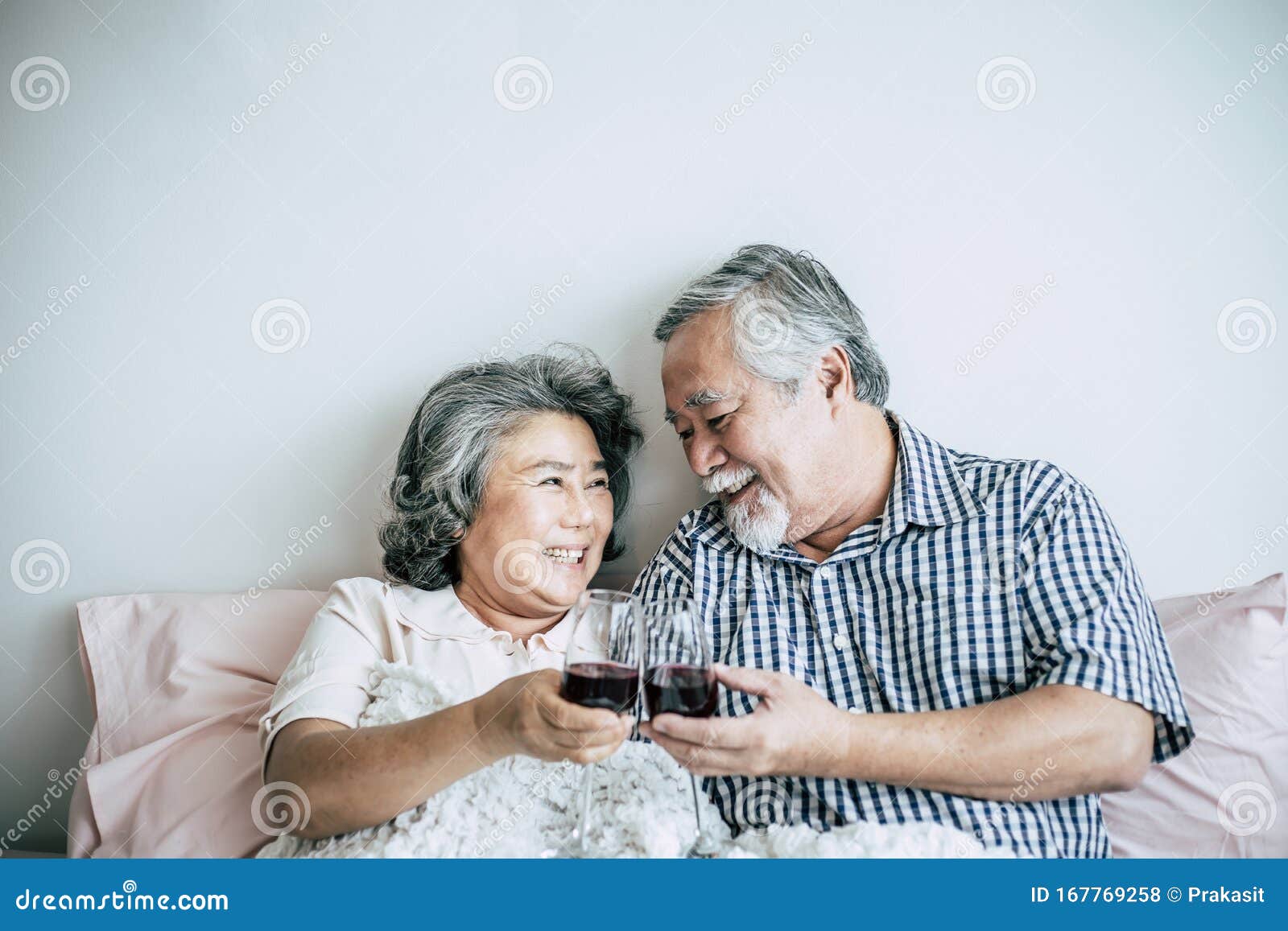 Elderly couple in bed room stock photo. Image of relax - 167769258