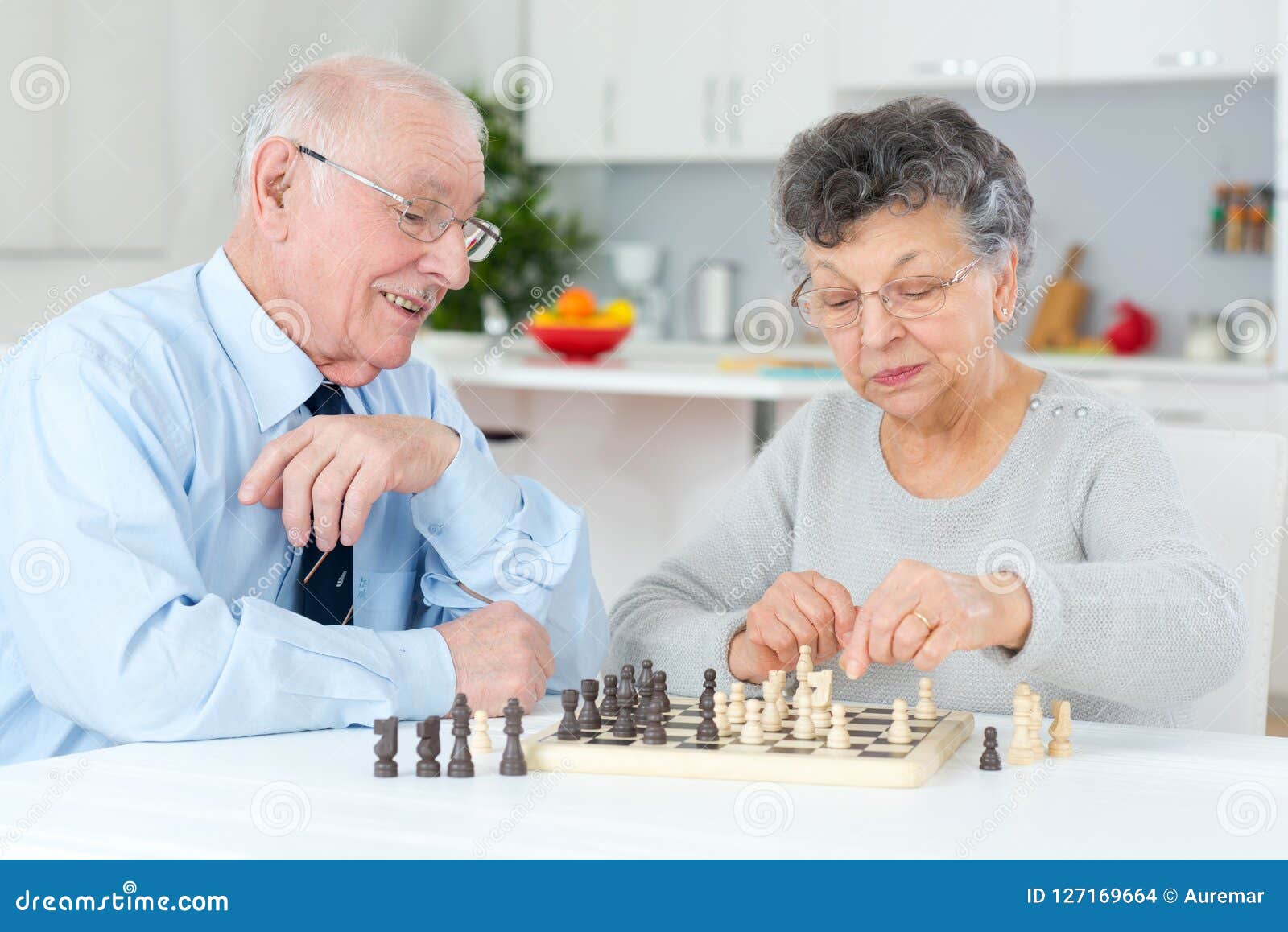 Elderly Couple at Home Playing Chess Stock Photo - Image of aged ...