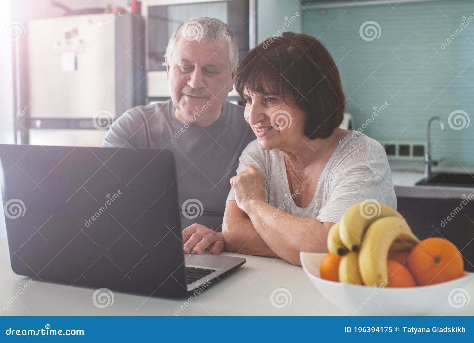 Elderly Couple Looking at Computer in the Kitchen Stock Image - Image ...