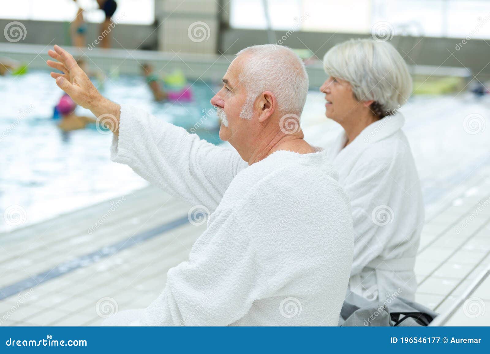 Elderly Couple Lying Waving at Someone on Pool Deck Stock Image - Image ...