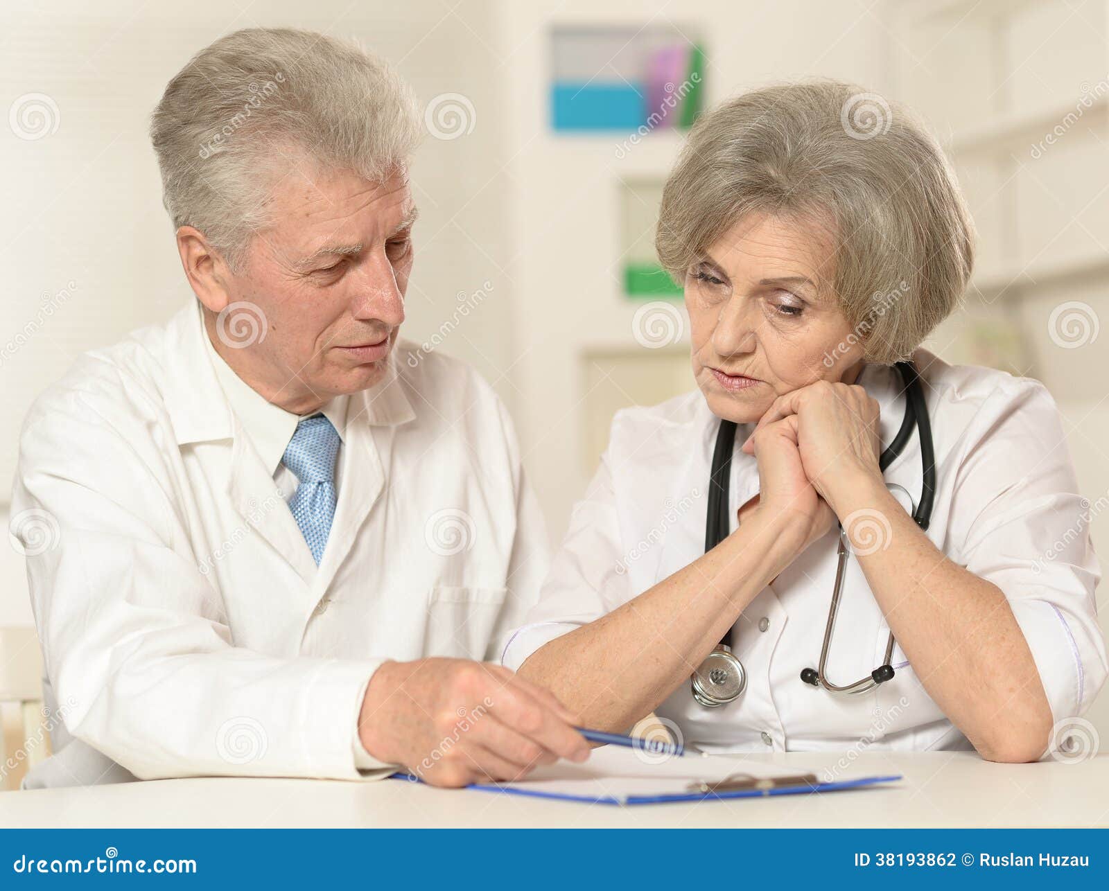 Elderly doctors at table stock photo. Image of portrait - 38193862