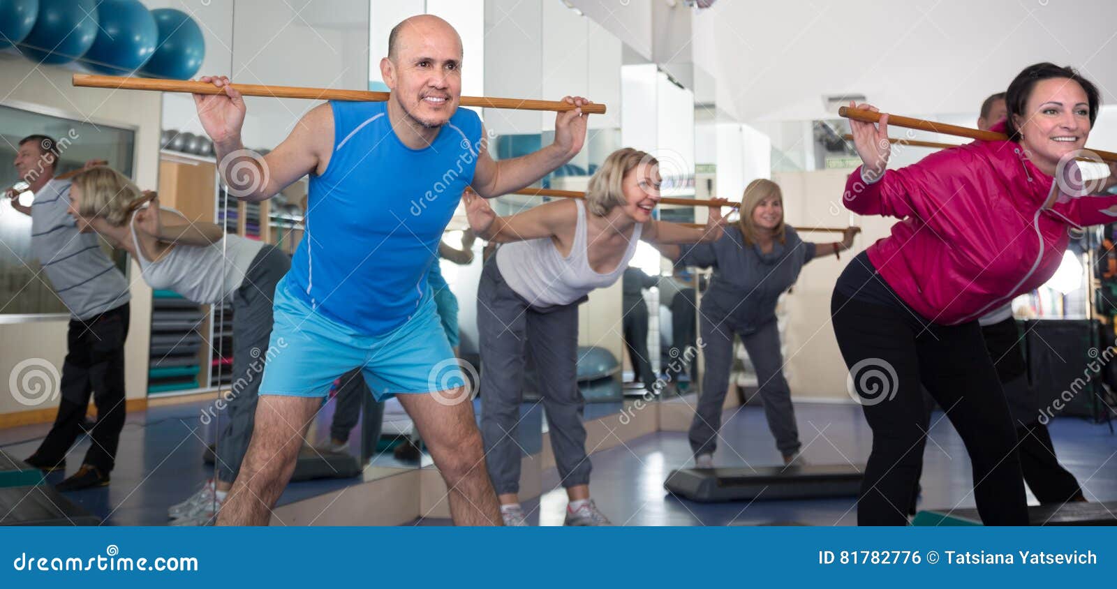 Elderly Exercise with Gymnastic Sticks in Modern Gym Stock Photo ...