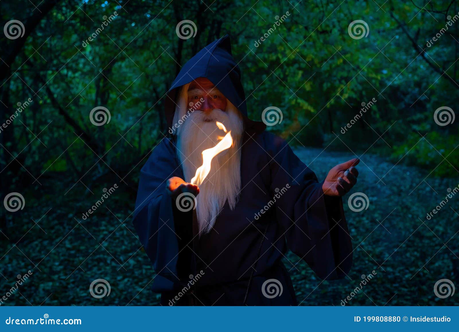 An Elderly Gray-haired Witcher Casts a Fire Spell in the Forest. Man in ...