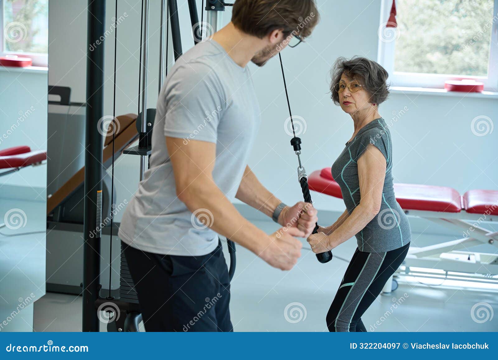 Elderly Lady Performs Rehabilitation Exercises on a Simulator Stock ...