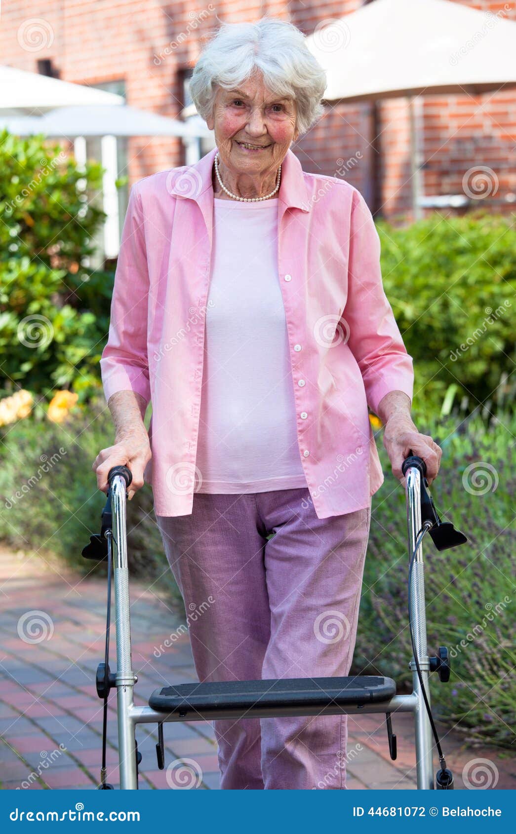Elderly Lady Using a Walker in the Garden Stock Photo - Image of ...