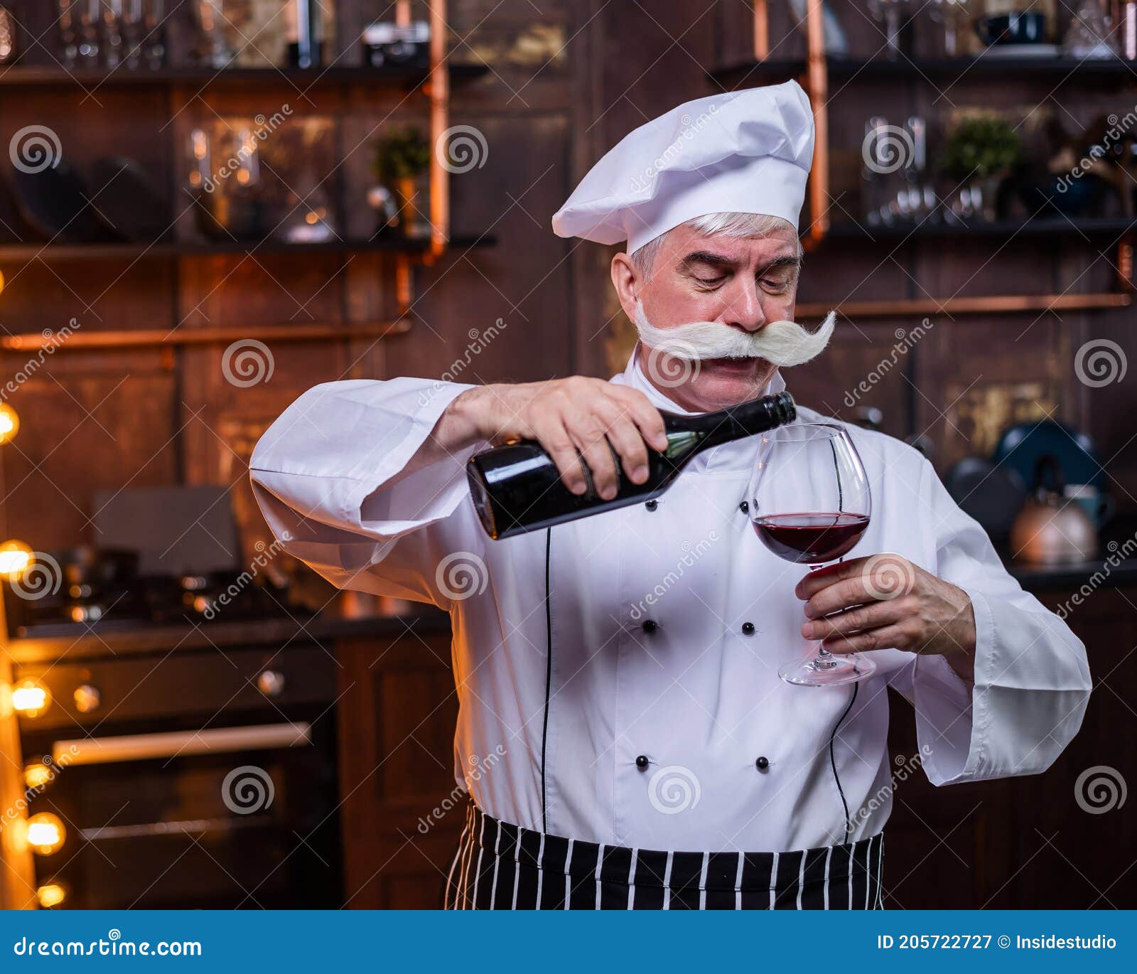 An Elderly Male Chef Degustation Red Wine in the Kitchen Stock Image ...