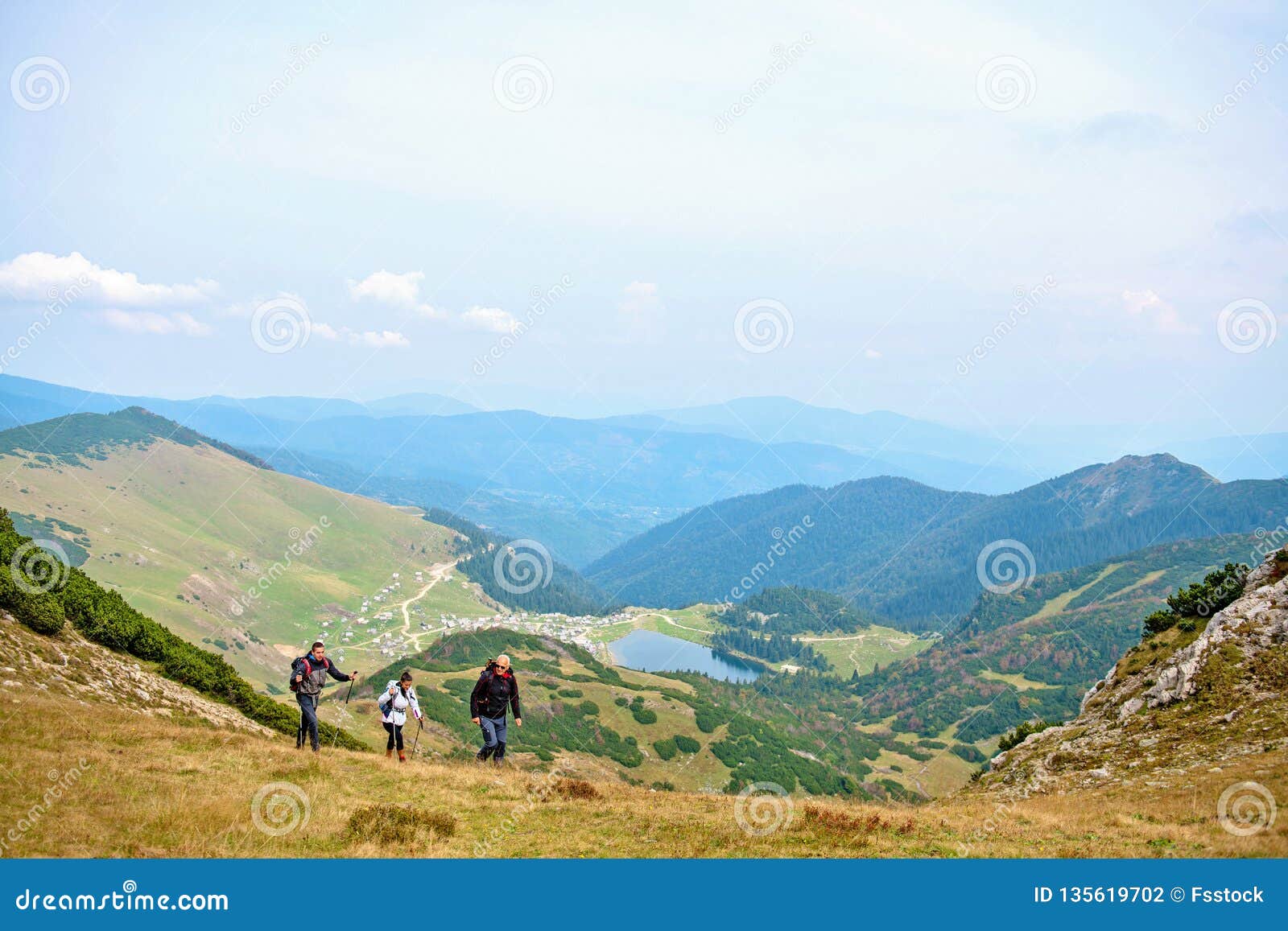 An Elderly Man Giving a Tour for a Young Group of People Stock Photo ...