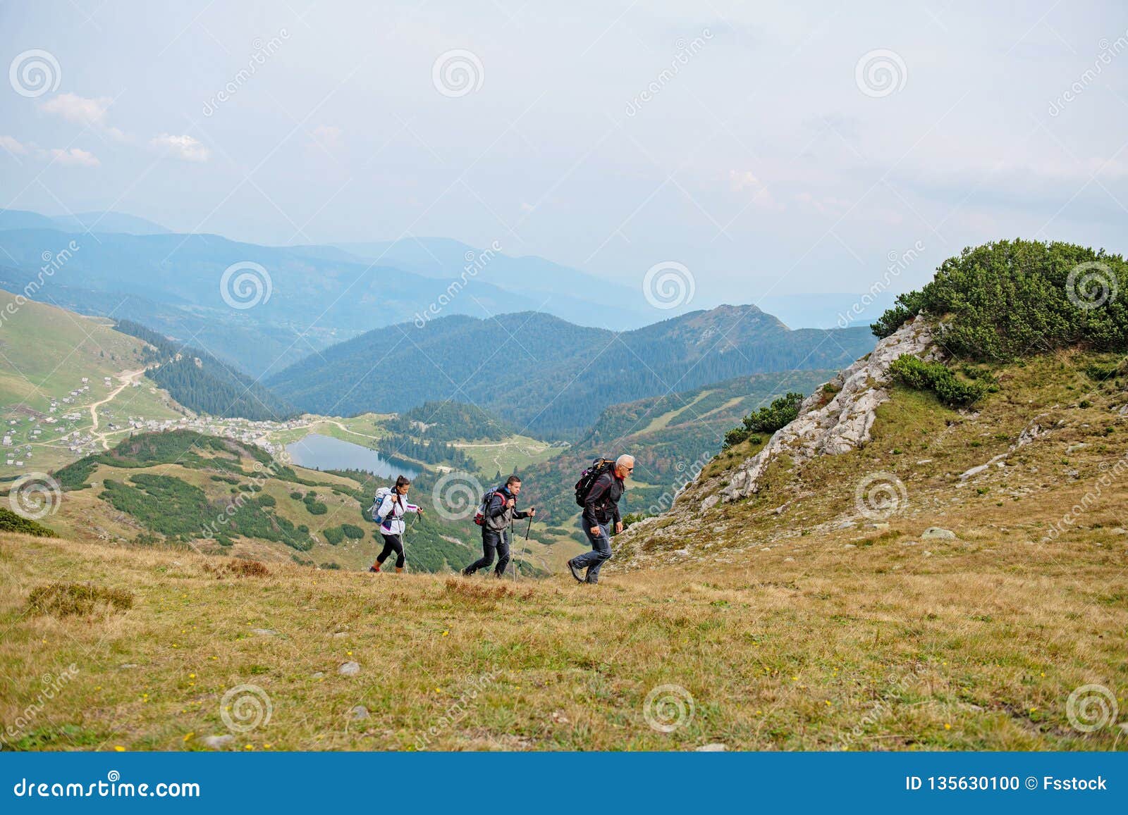An Elderly Man Giving a Tour for a Young Group of People Stock Photo ...