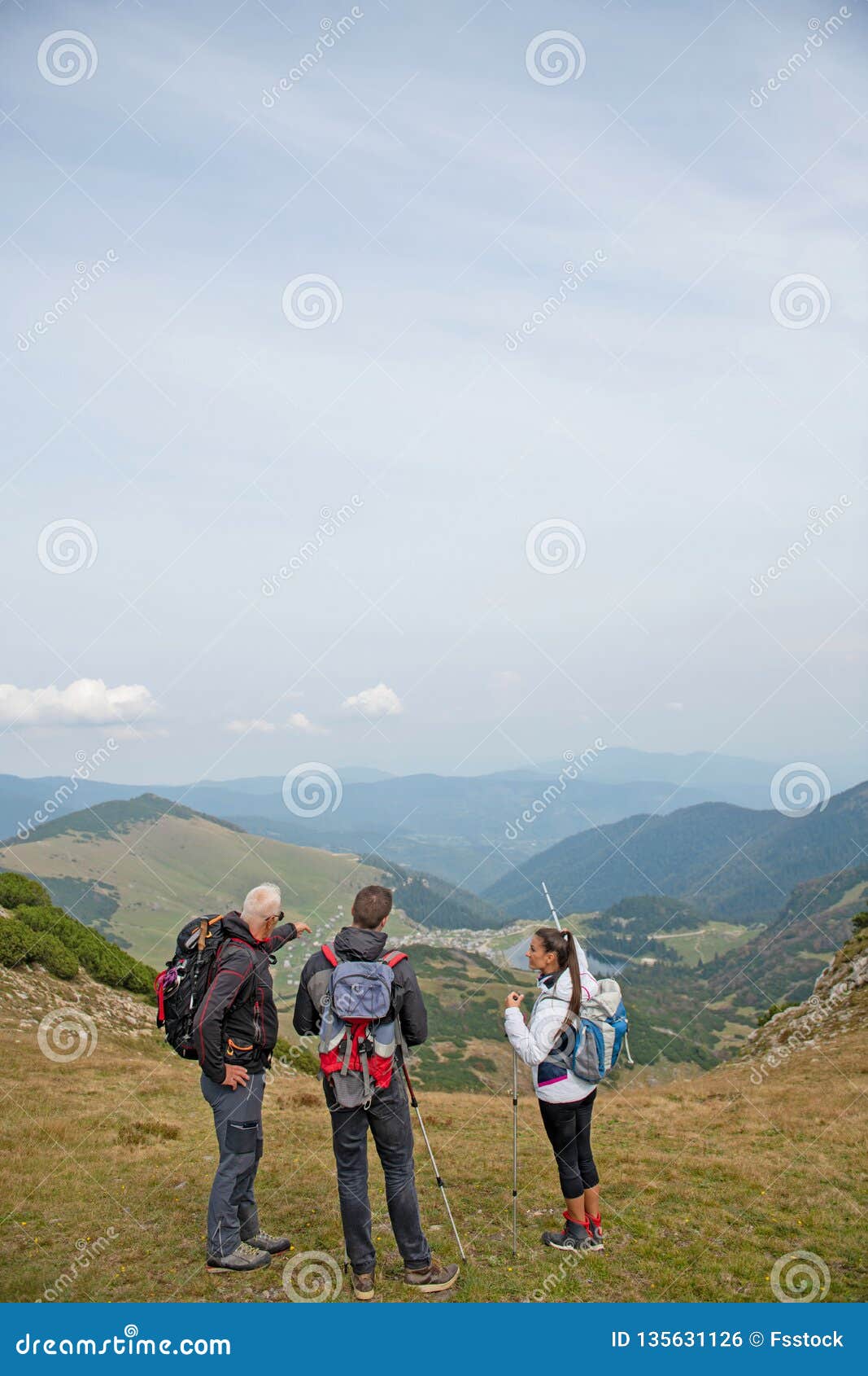 An Elderly Man Giving a Tour for a Young Group of People Stock Photo ...