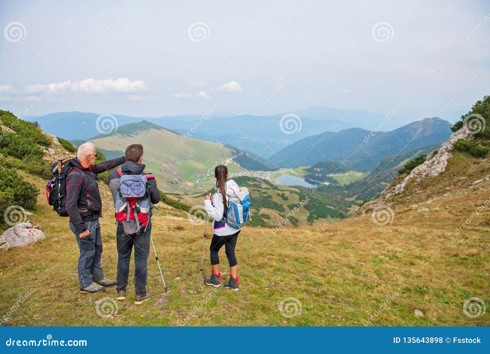 An Elderly Man Giving a Tour for a Young Group of People Stock Photo ...