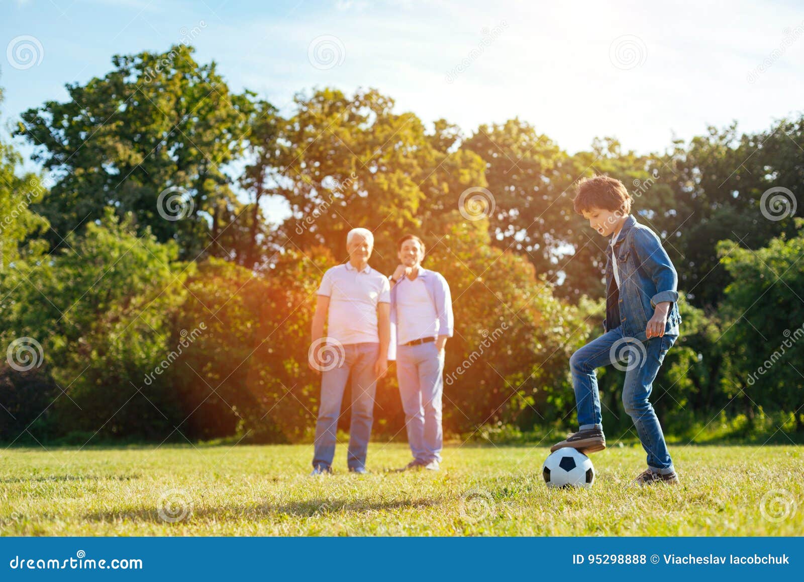 Elderly Man and His Son Watching the Kid Playing Stock Photo - Image of ...