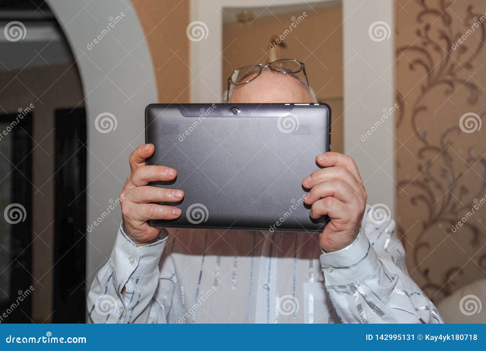 Elderly Man Holding Tablet on Lap, Planning and Booking Retirement Trip ...