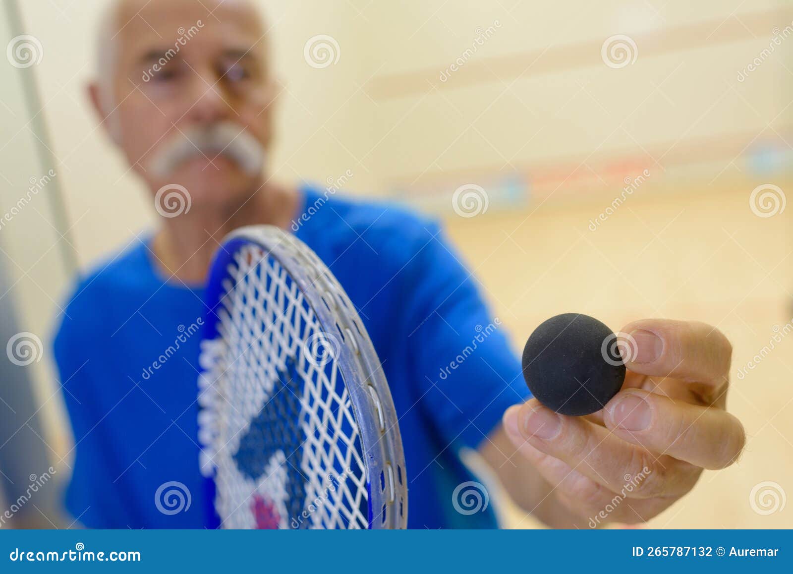 Elderly Man Holding Tiny Black Tennis Ball Stock Photo - Image of ...