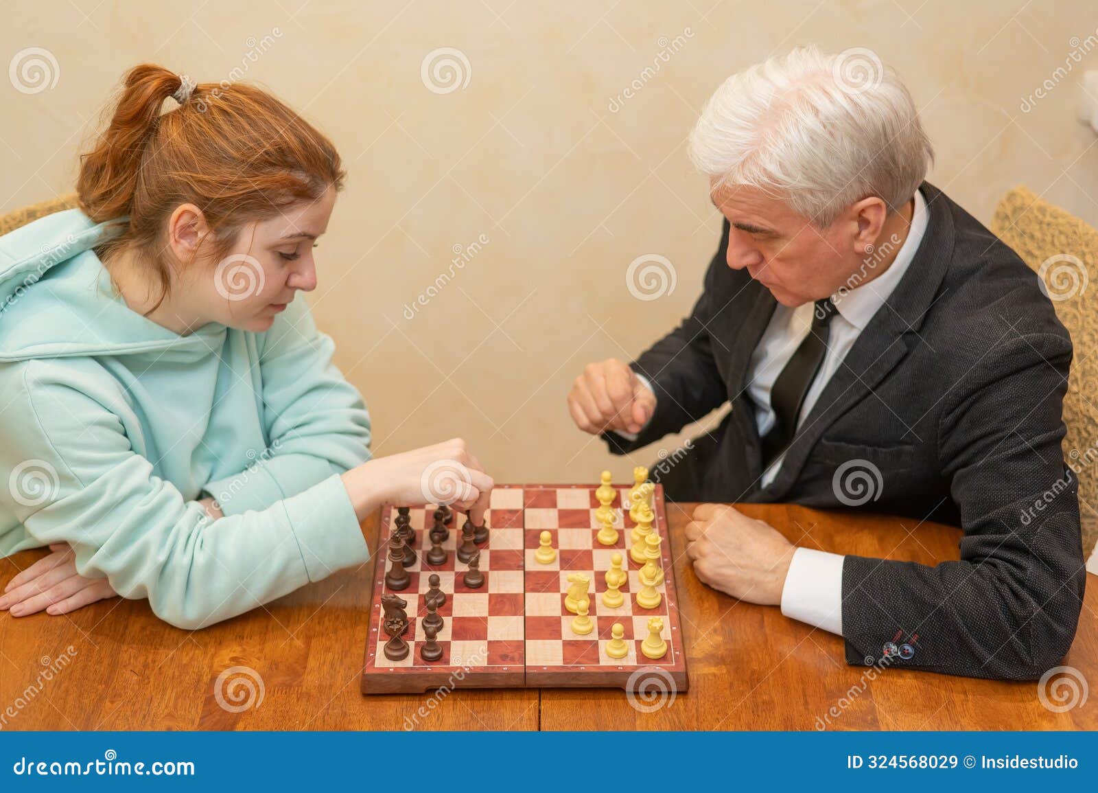 An Elderly Man and a Middle-aged Woman Play Chess. Stock Image - Image ...